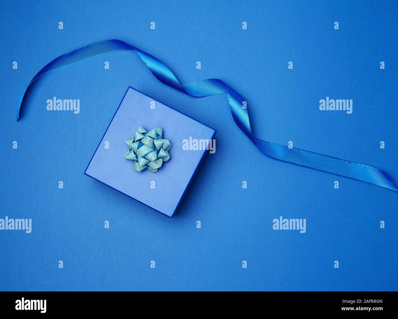 cardboard gift square box, bows, ribbons for packaging on a dark blue ...