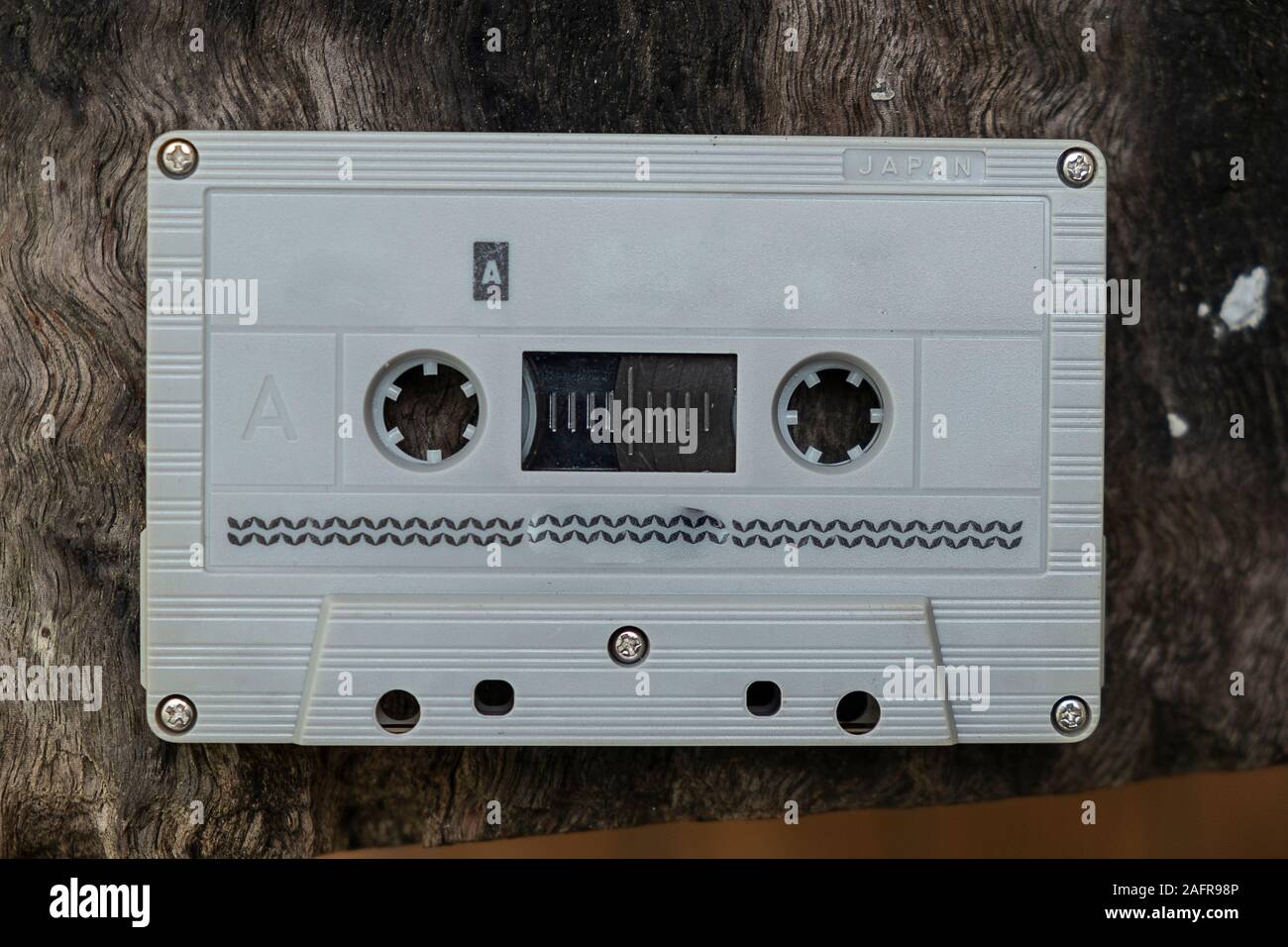 women rewind a cassette tape Vintage compact cassette on wood ...