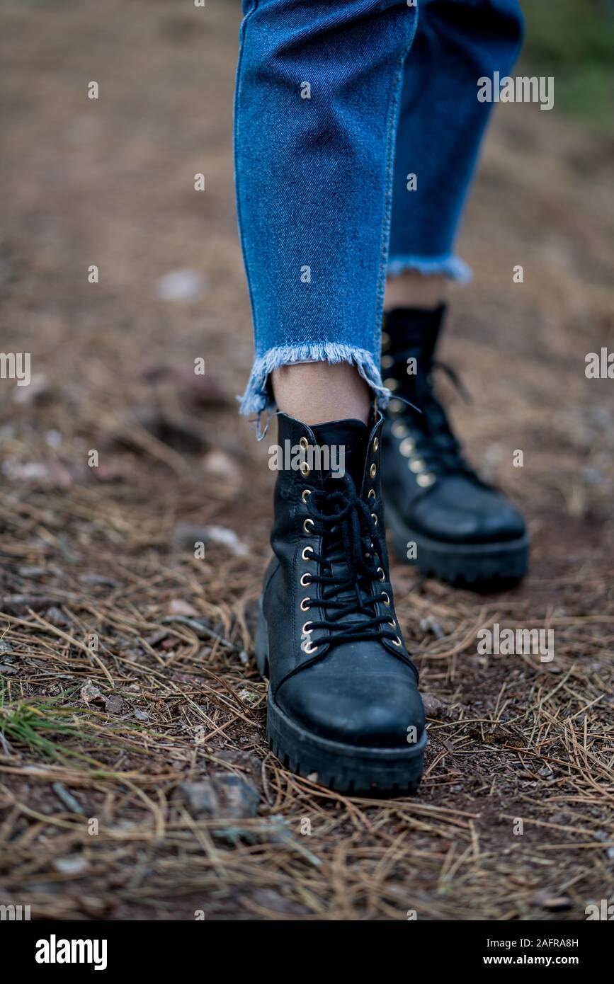 unisex black boots close-up photo in forest Stock Photo - Alamy