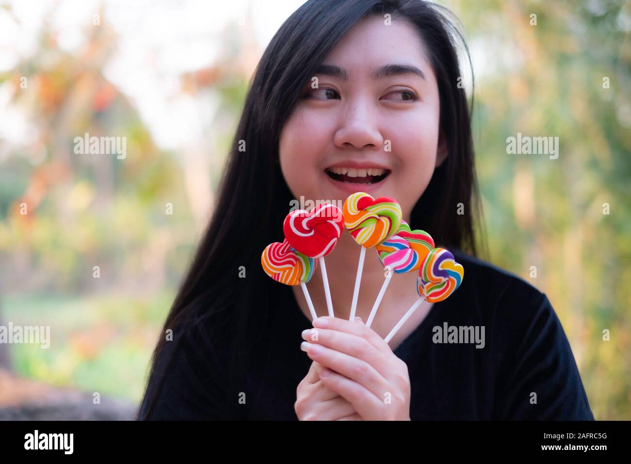 Sweets candies heart shape color full in hand women on blurred ...