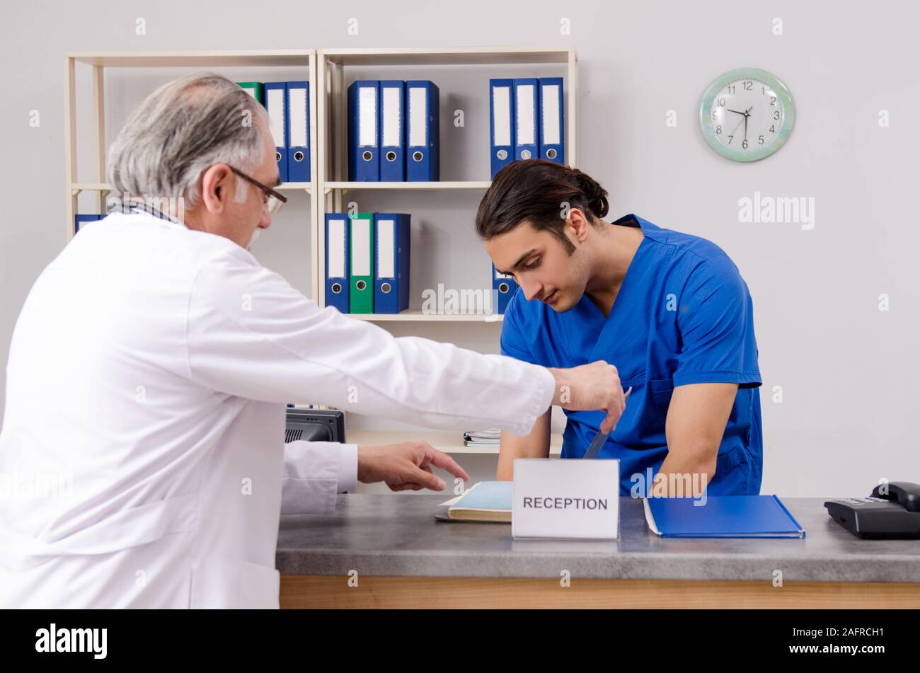 Doctors talking at the reception in hospital Stock Photo - Alamy