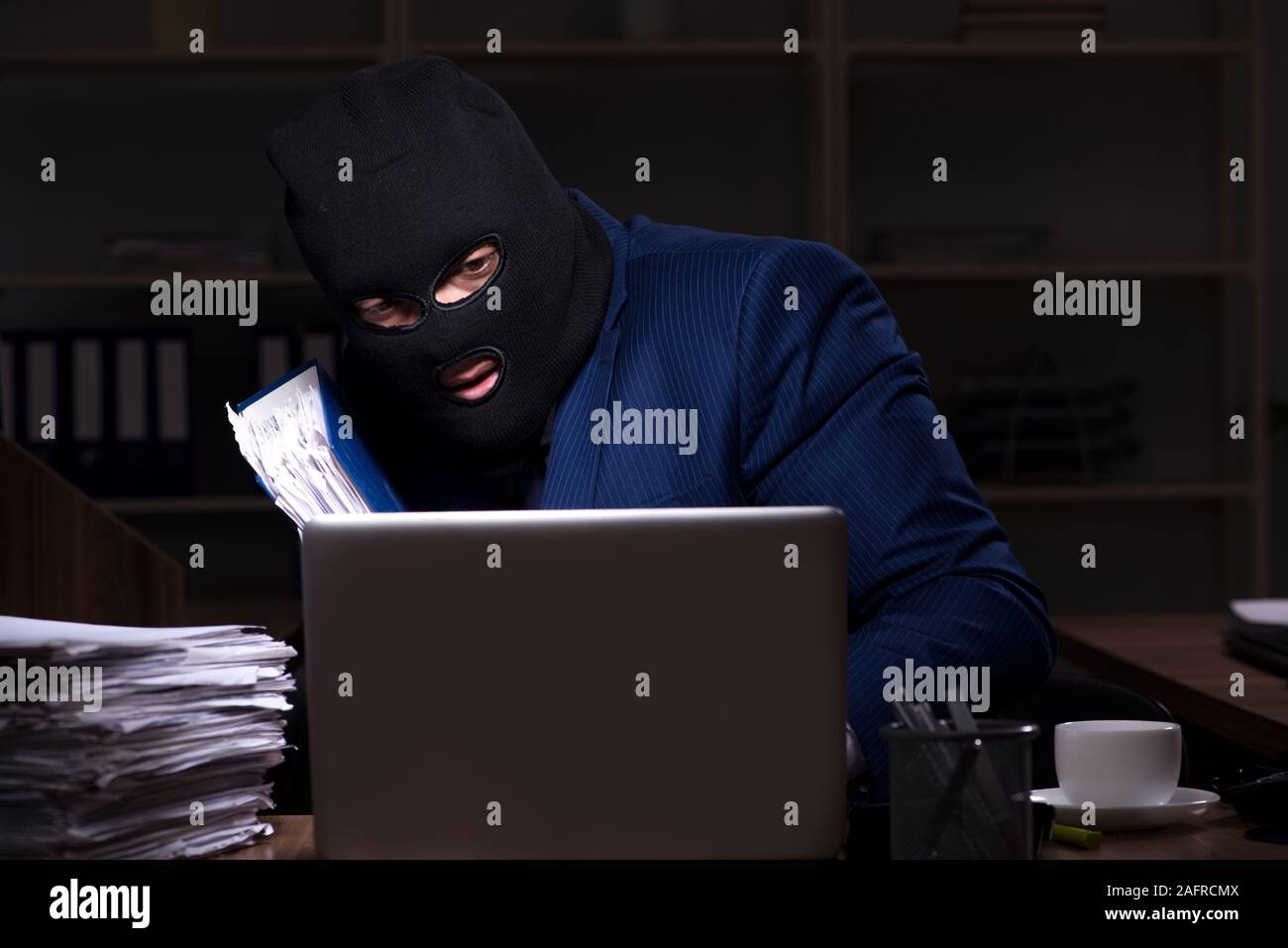 The male employee stealing information in the office night time Stock ...
