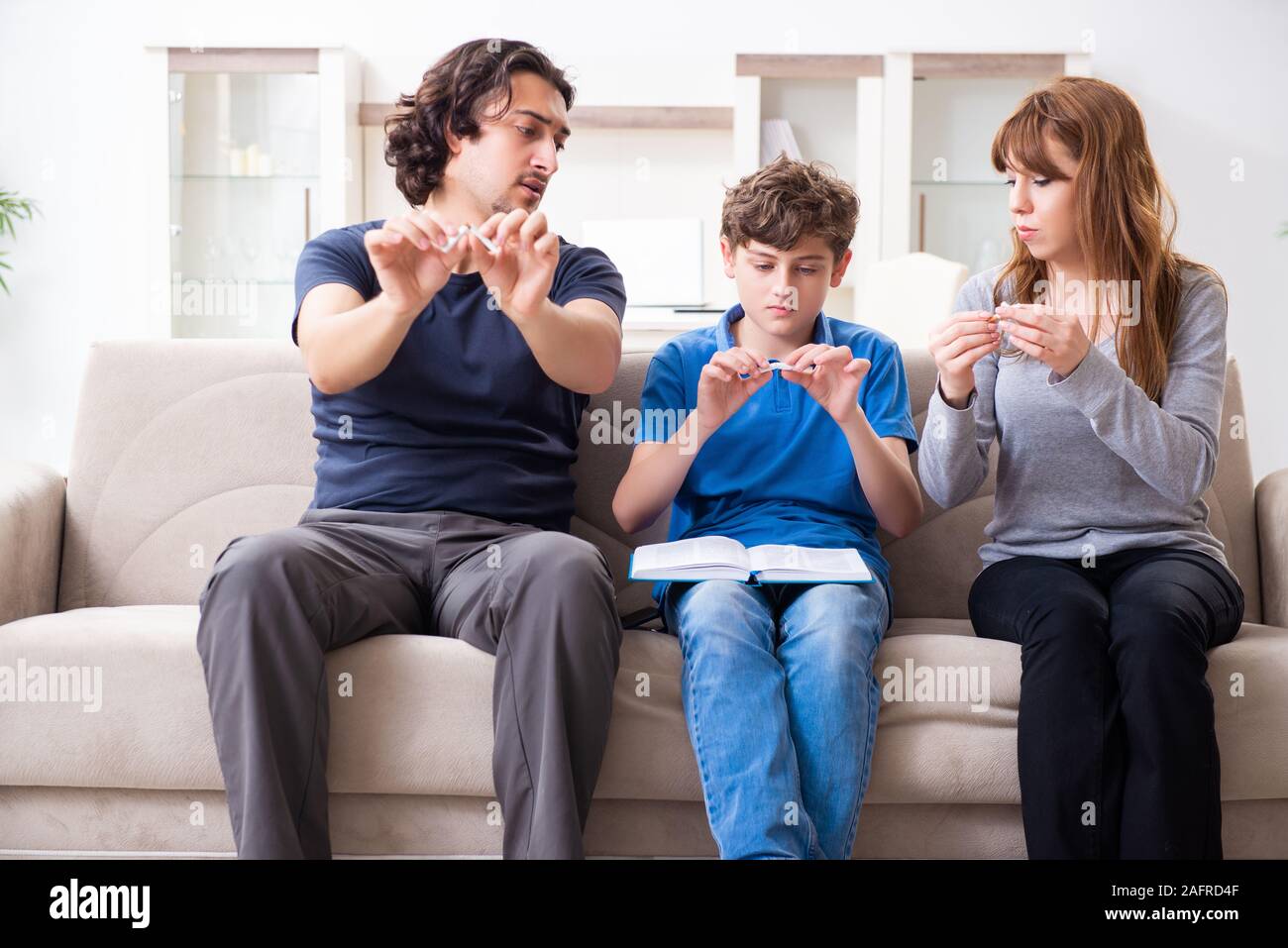 The concept of underage smoking with young boy and family Stock Photo ...
