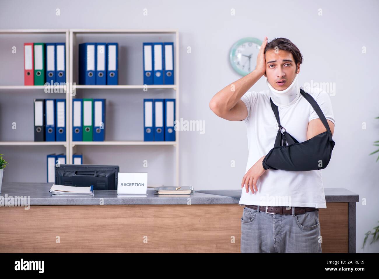 Clinic reception counter and young patient Stock Photo - Alamy