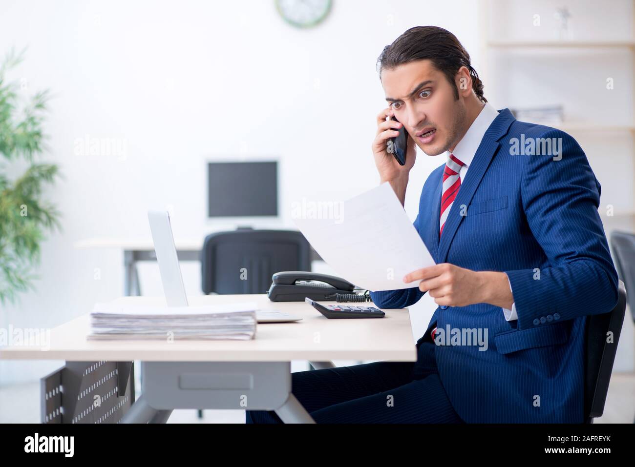 Confused businessman looking papers hi-res stock photography and images ...