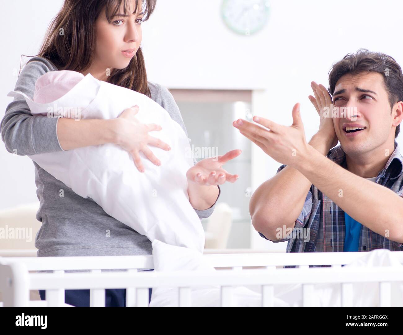 The young dad cannot stand baby crying Stock Photo - Alamy