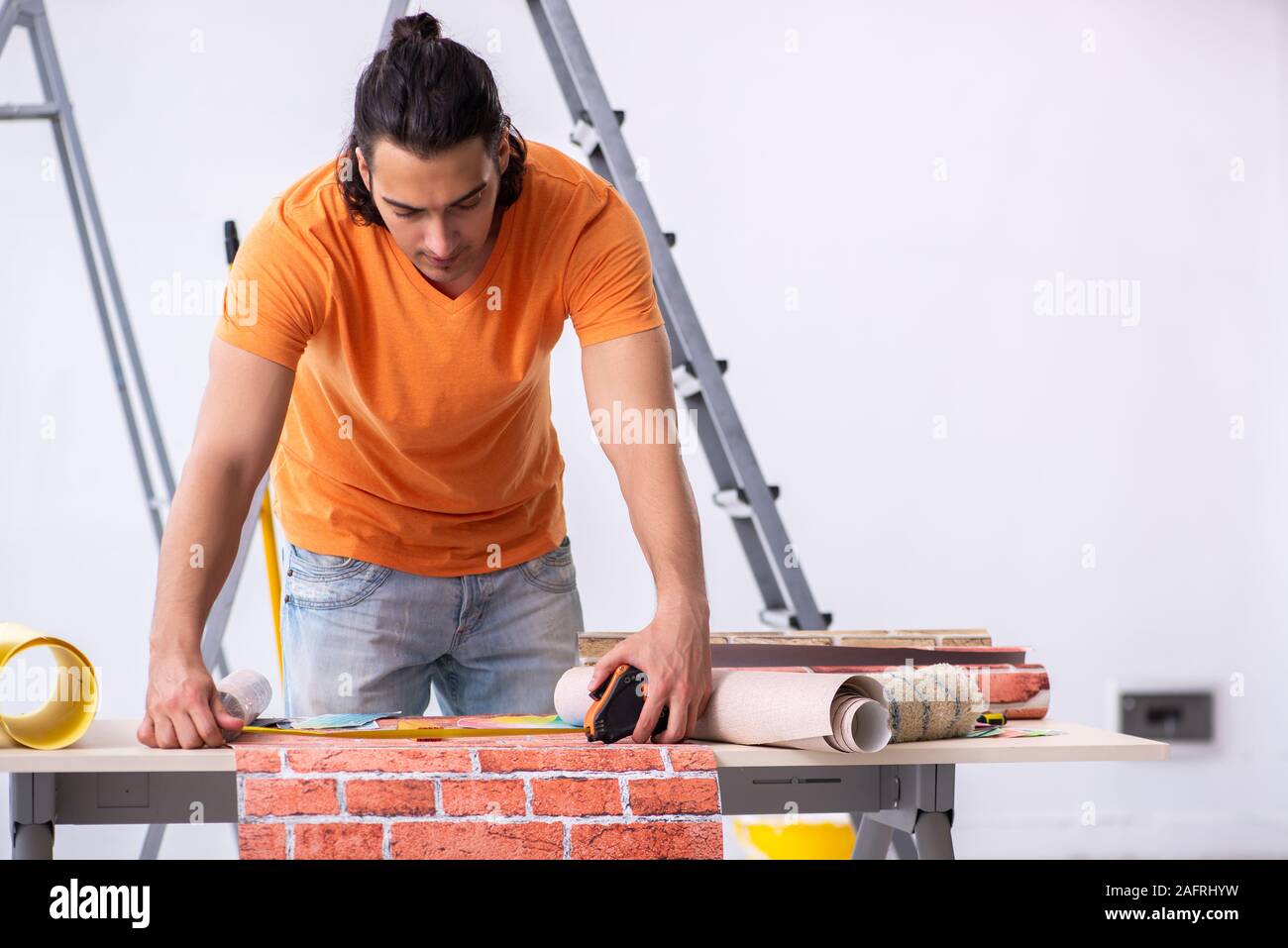 The young man contractor doing renovation at home Stock Photo - Alamy