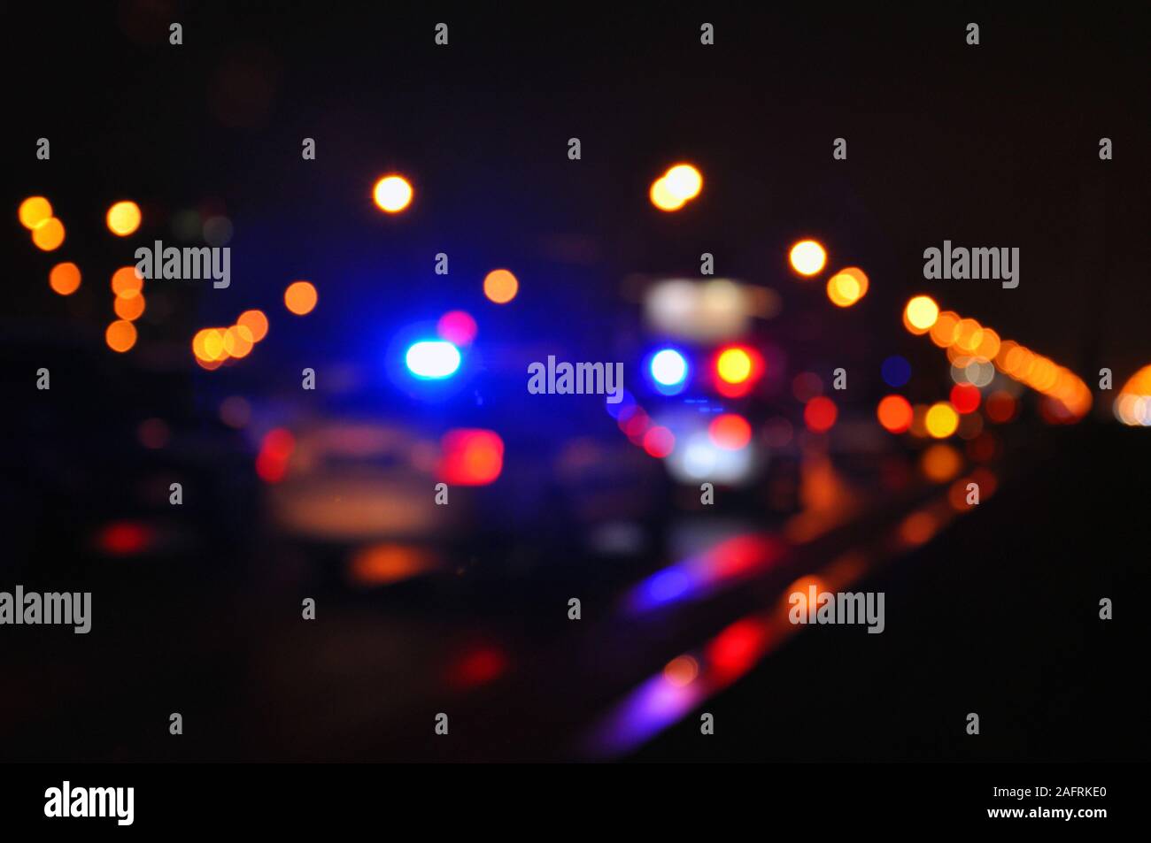 Blue light flasher atop of a police car. City lights on the background ...