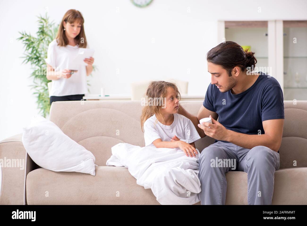 The father taking care of his ill daughter Stock Photo - Alamy