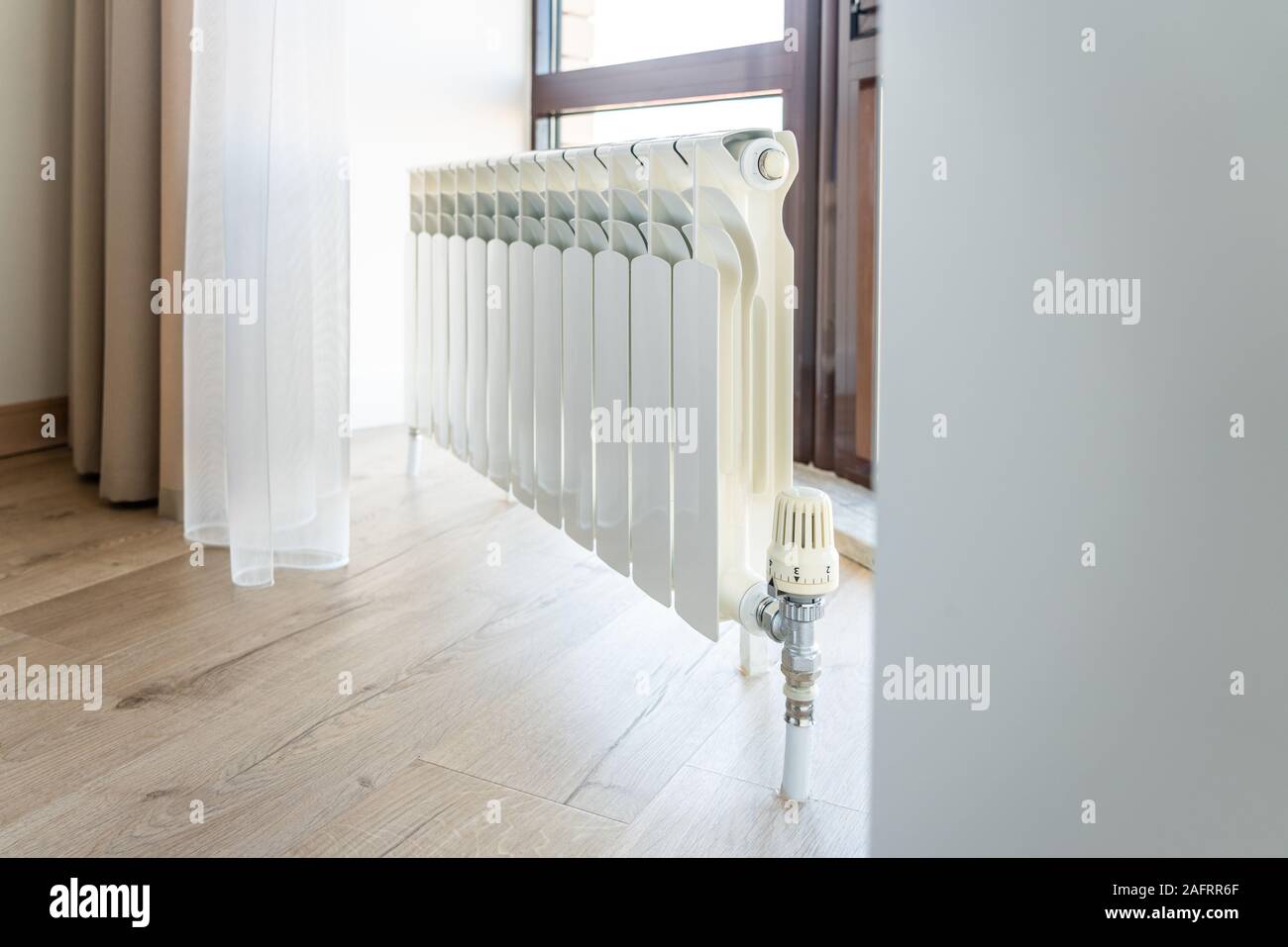 White big radiator near window in a modern room Stock Photo - Alamy