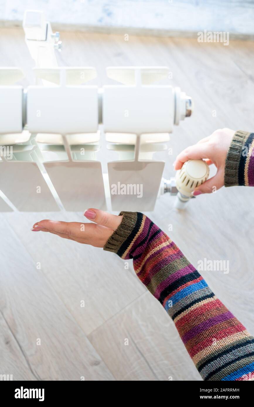 Radiator adjustment closeup, Female hand adjusting radiator temperature ...