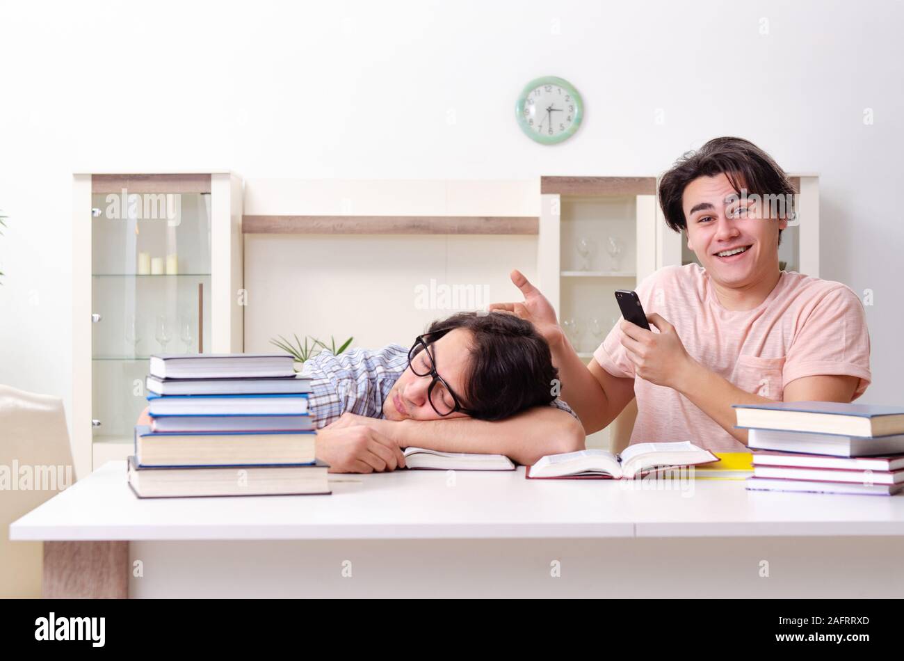 The two male students preparing for exams at home Stock Photo - Alamy