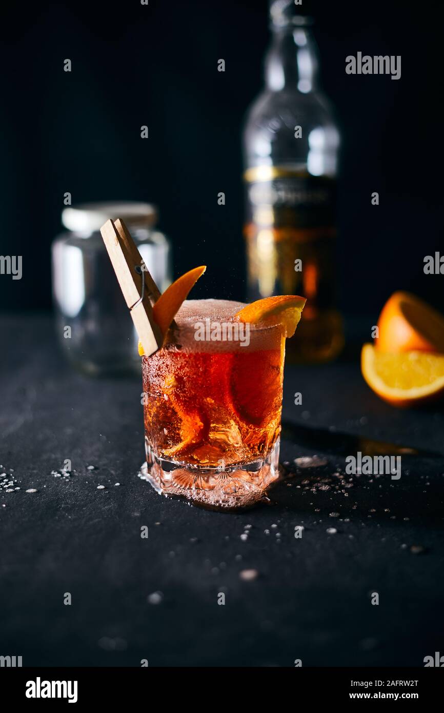 Alcoholic cocktail with orange peel and ice Stock Photo - Alamy