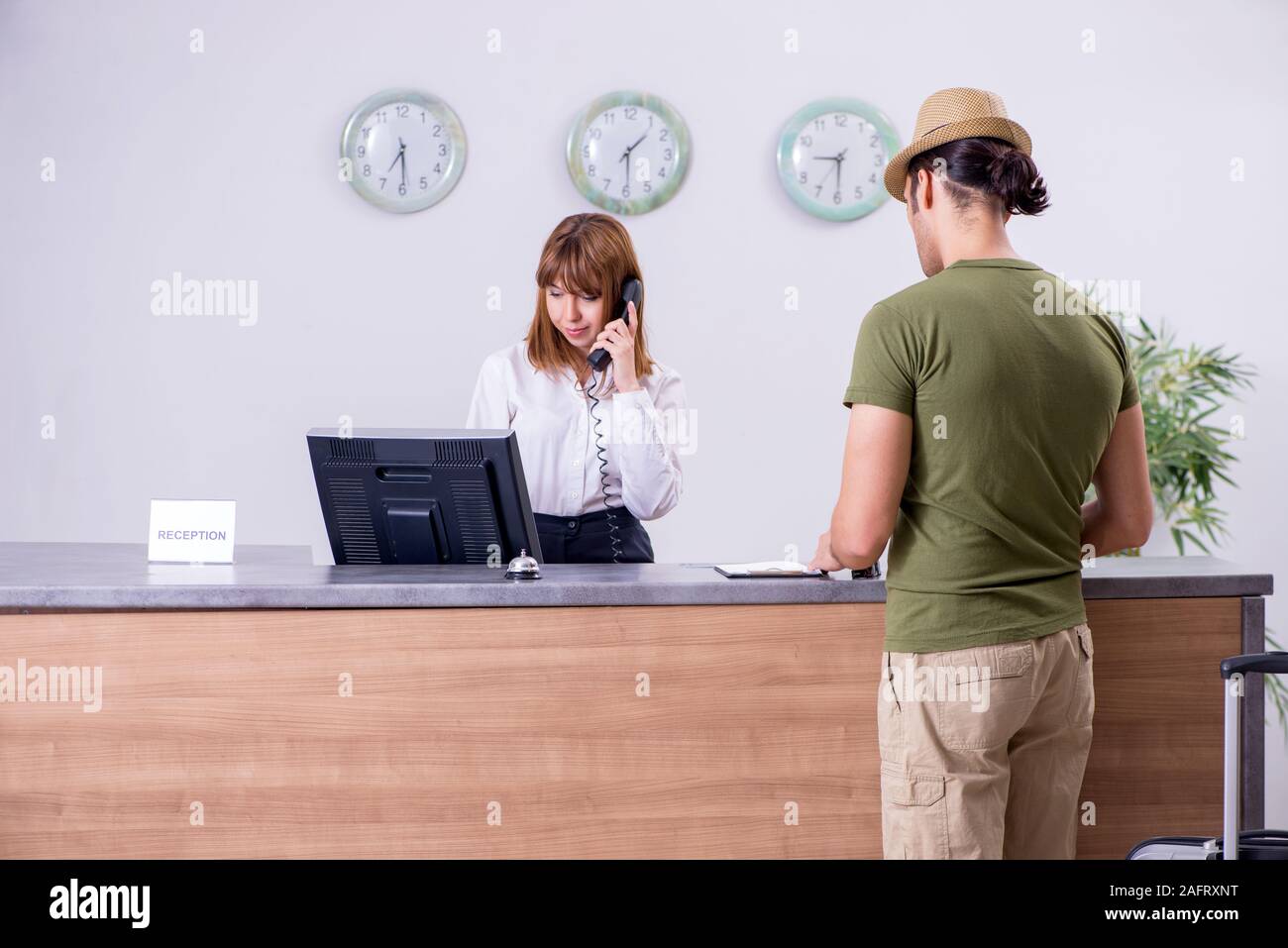 The young man at the hotel reception Stock Photo - Alamy