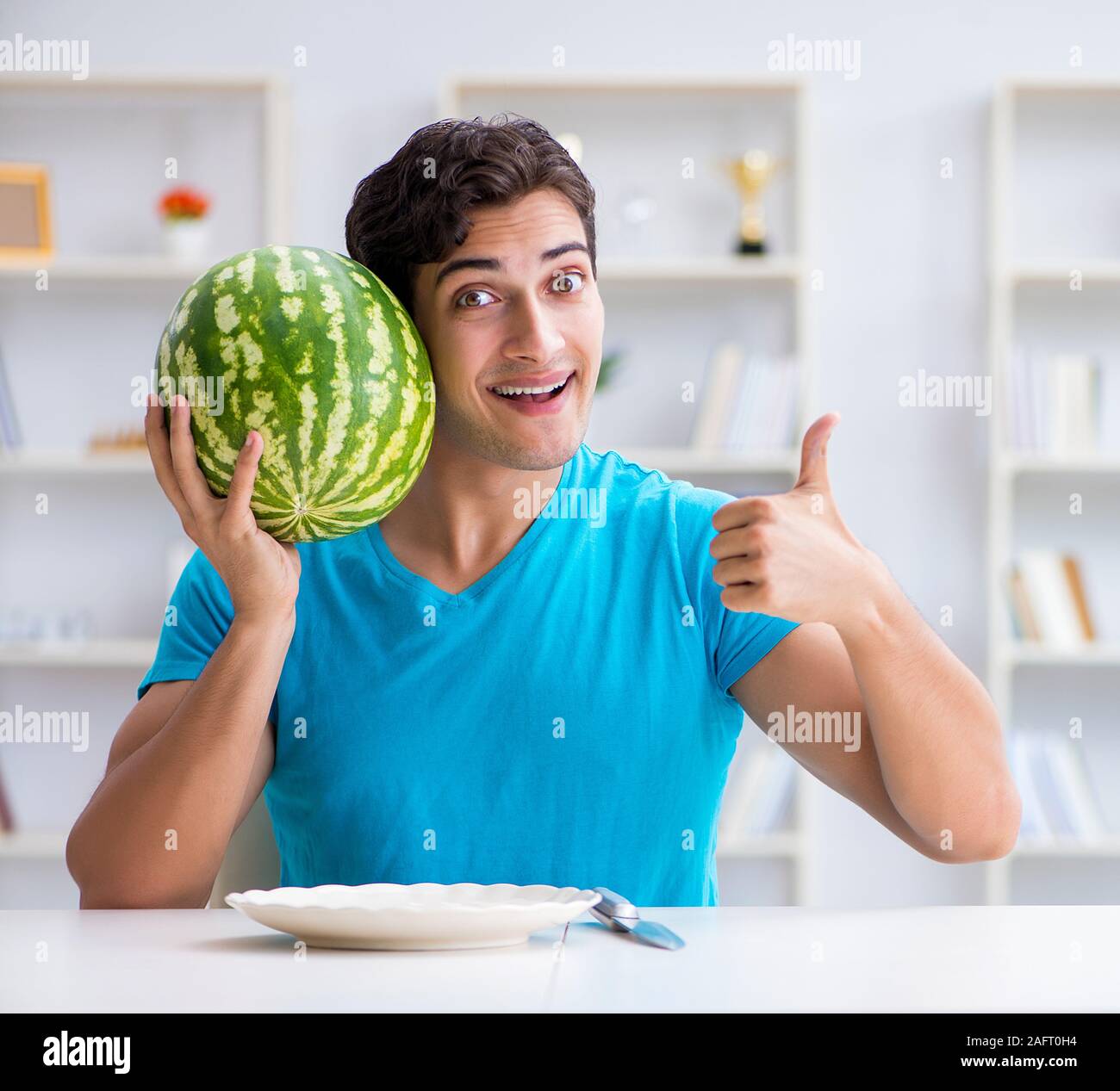 The man eating watermelon at home Stock Photo - Alamy