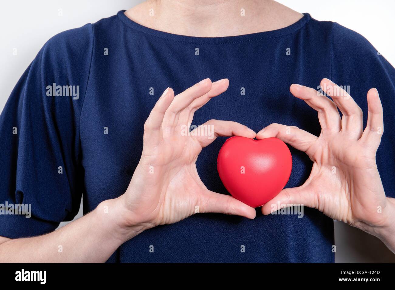 Heart health, anxiety, stress or love concept. Red rubber heart in ...