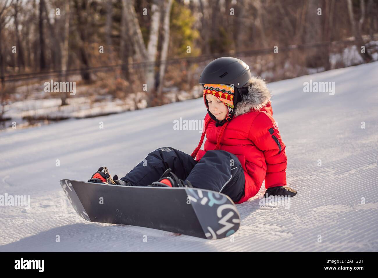 Little cute boy snowboarding. Activities for children in winter ...