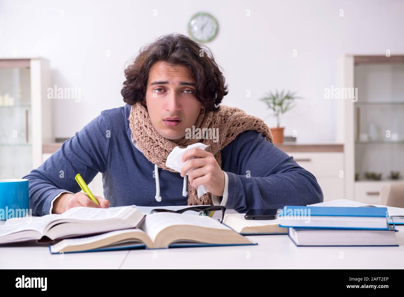 The sick male student suffering at home Stock Photo - Alamy