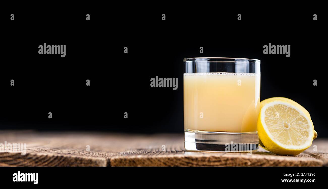 Fresh made Juice (lemon) on an old and rustic wooden table (selective ...