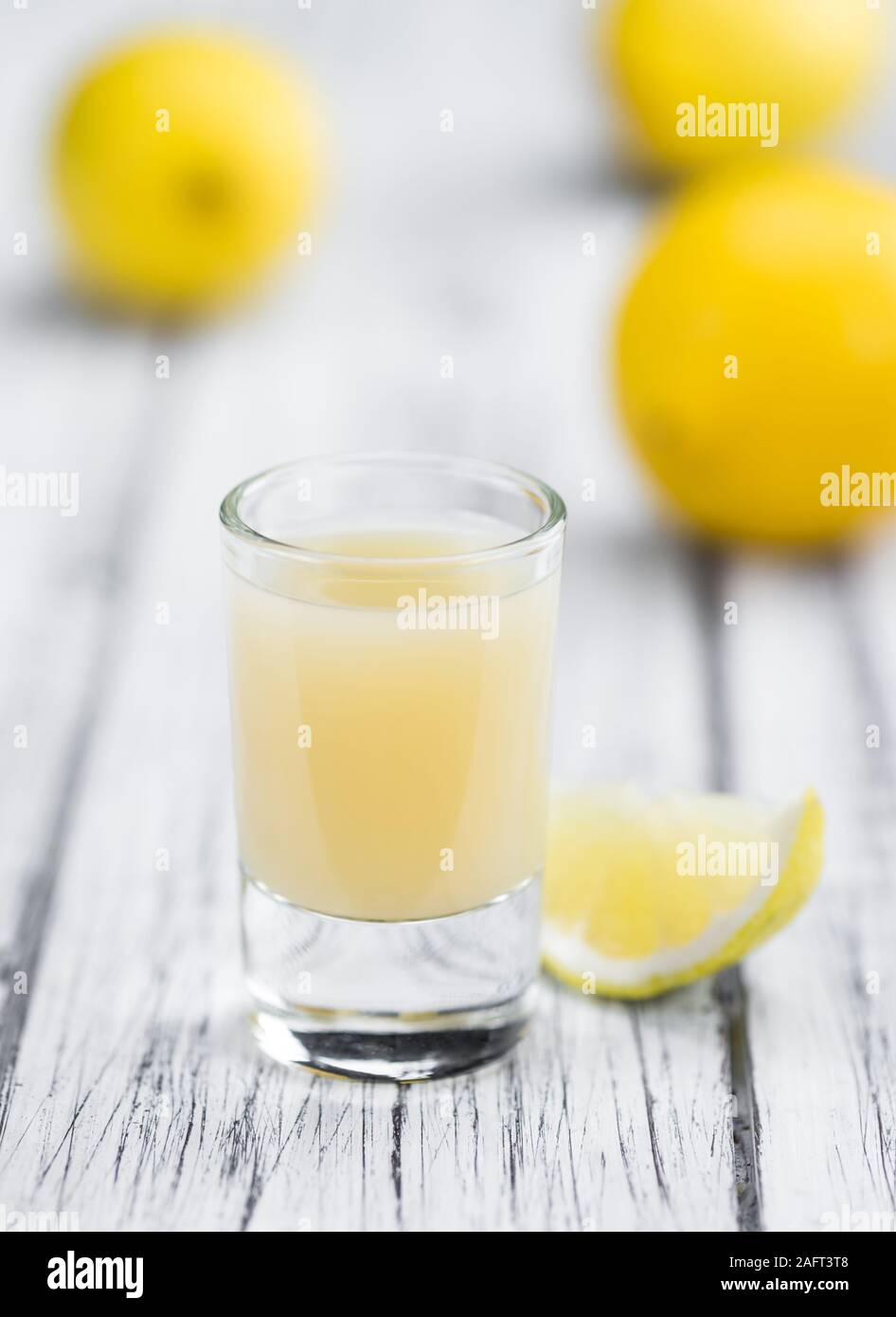 Fresh made Juice (lemon) on an old and rustic wooden table (selective ...