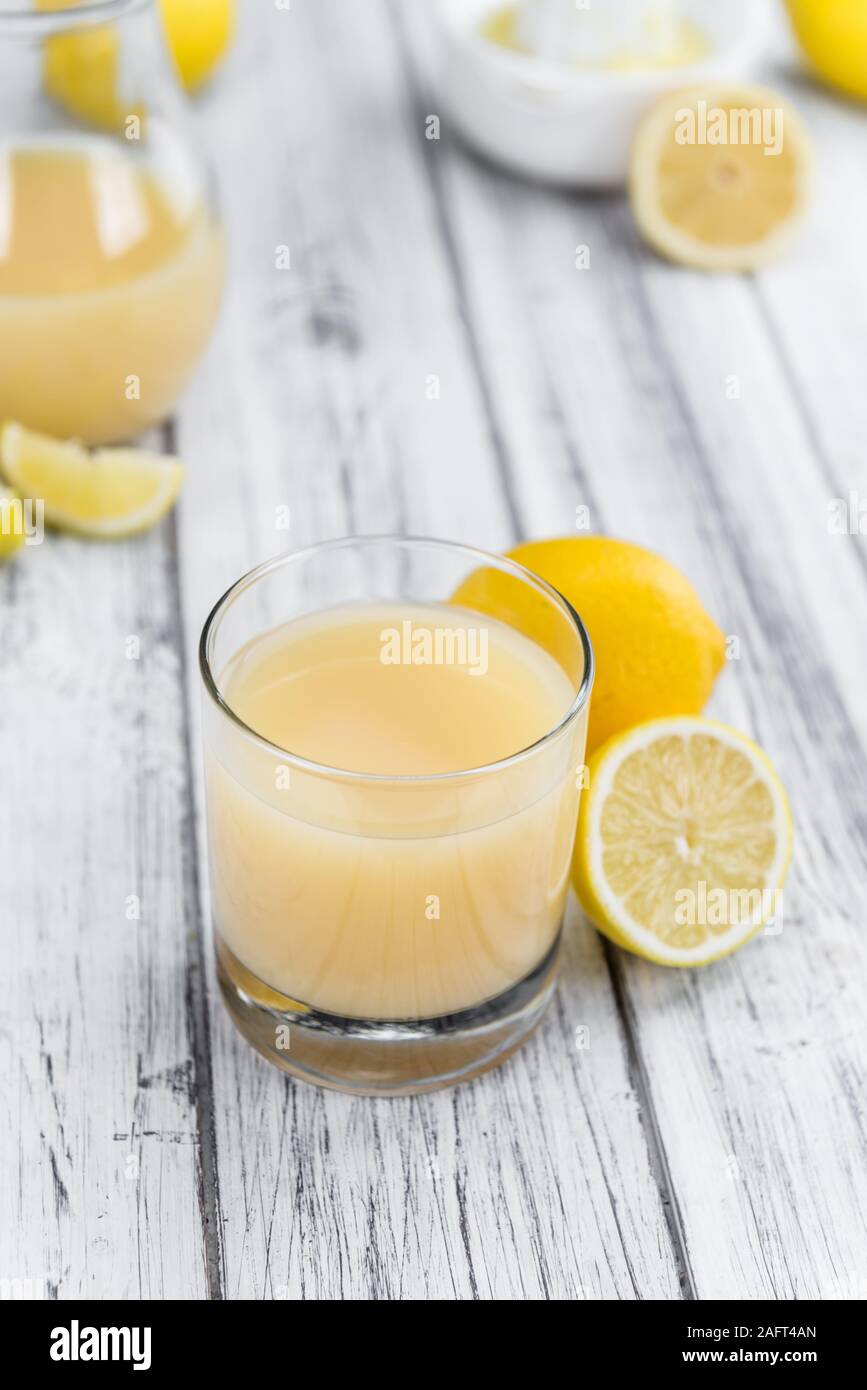 Homemade Lemon Juice on an wooden table (selective focus) as detailed ...