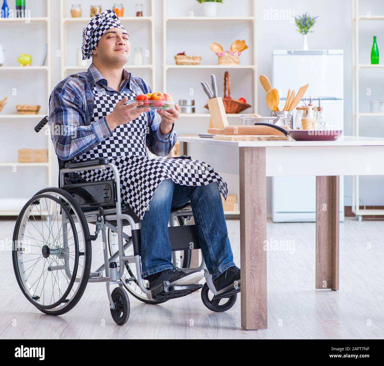 The young disabled husband preparing food salad Stock Photo - Alamy