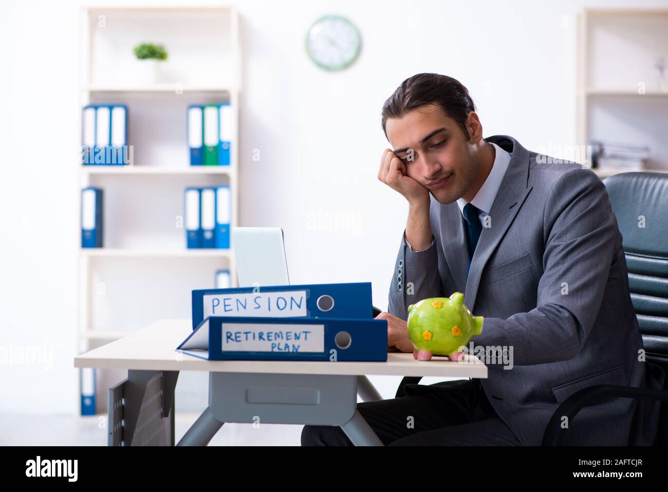 The young male accountant working in the office Stock Photo - Alamy