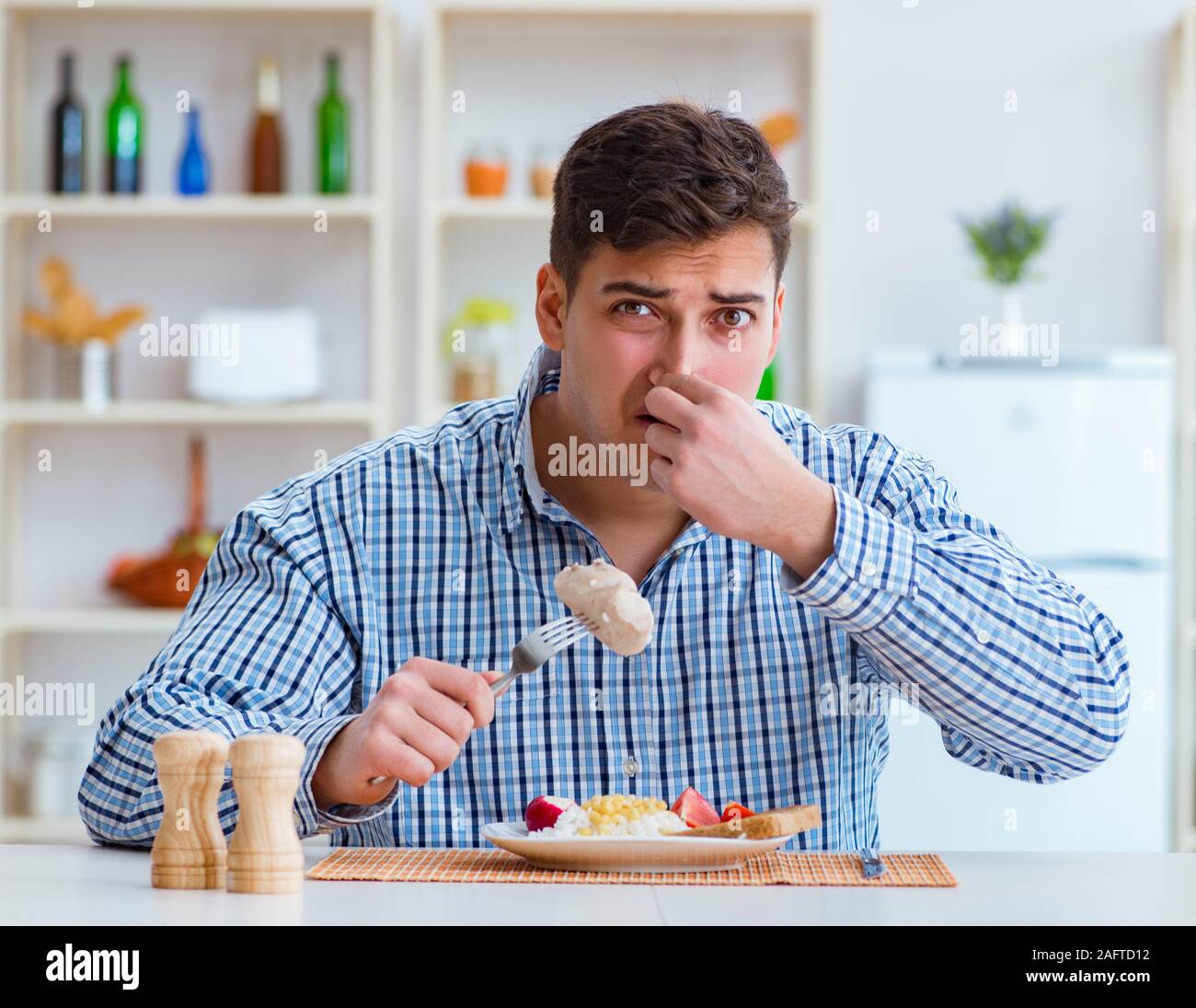 The man eating tasteless food at home for lunch Stock Photo - Alamy