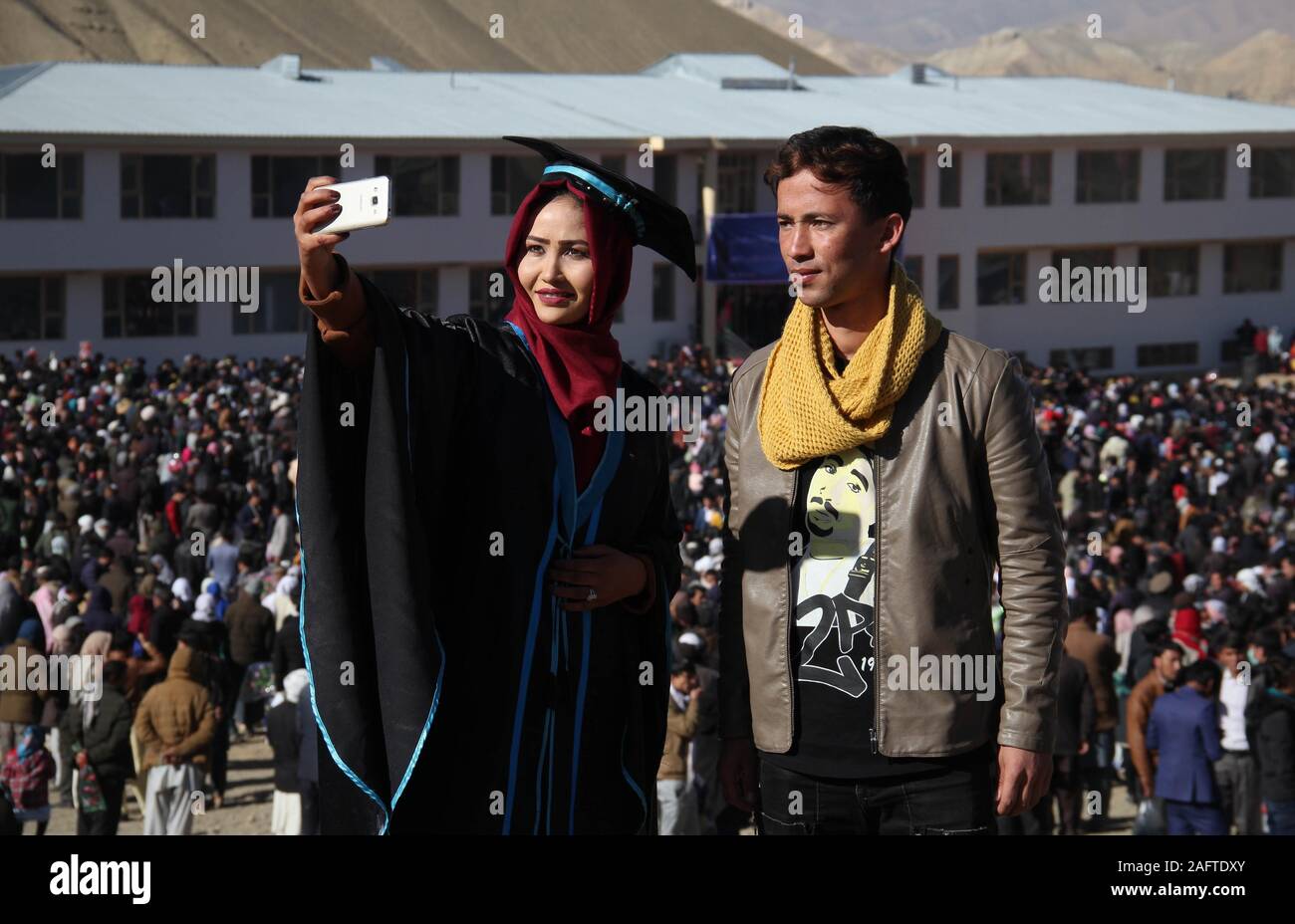 Bamiyan. 16th Dec, 2019. A student takes a selfie during her graduation ...