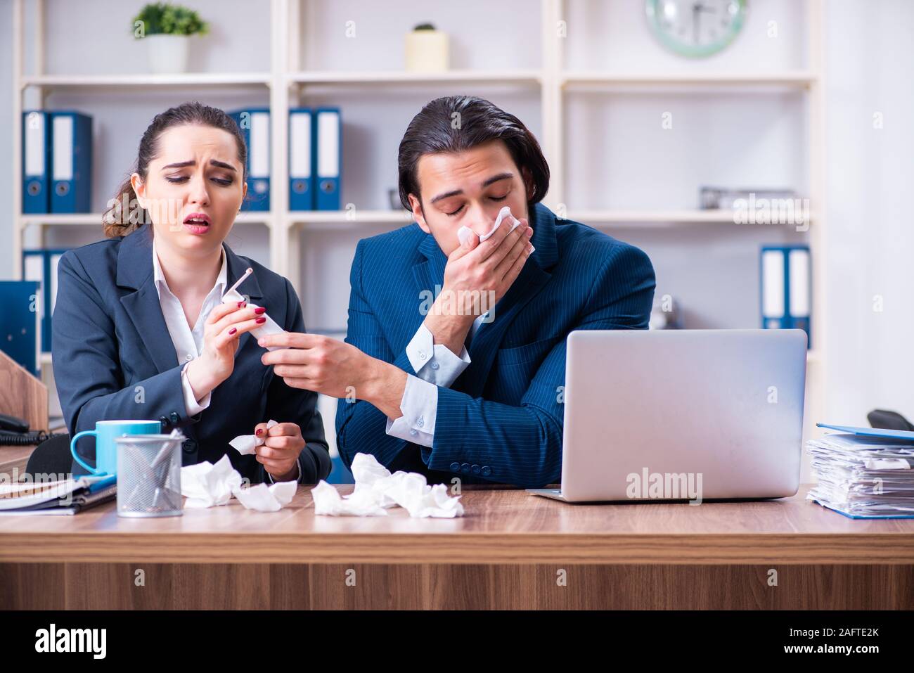 The two employees suffering at workplace Stock Photo - Alamy