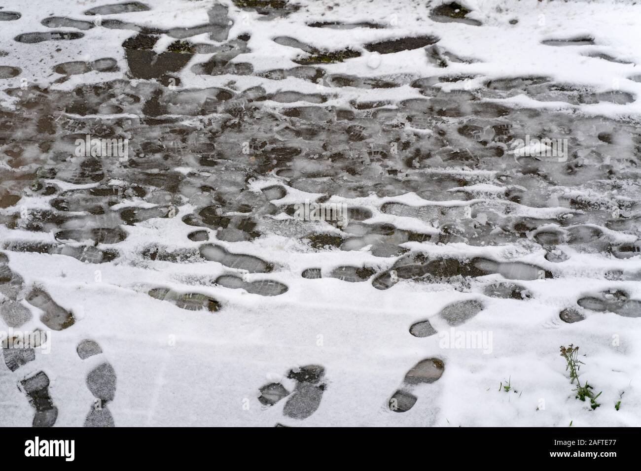 The first snow on the street. Traces on the snowy pavement. Winter ...