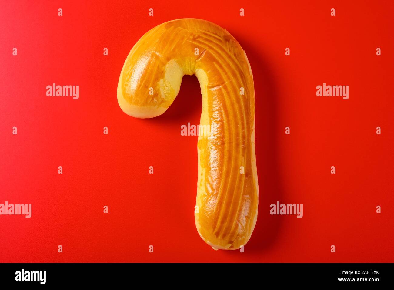 Christmas stick shape bread on a red background Stock Photo - Alamy