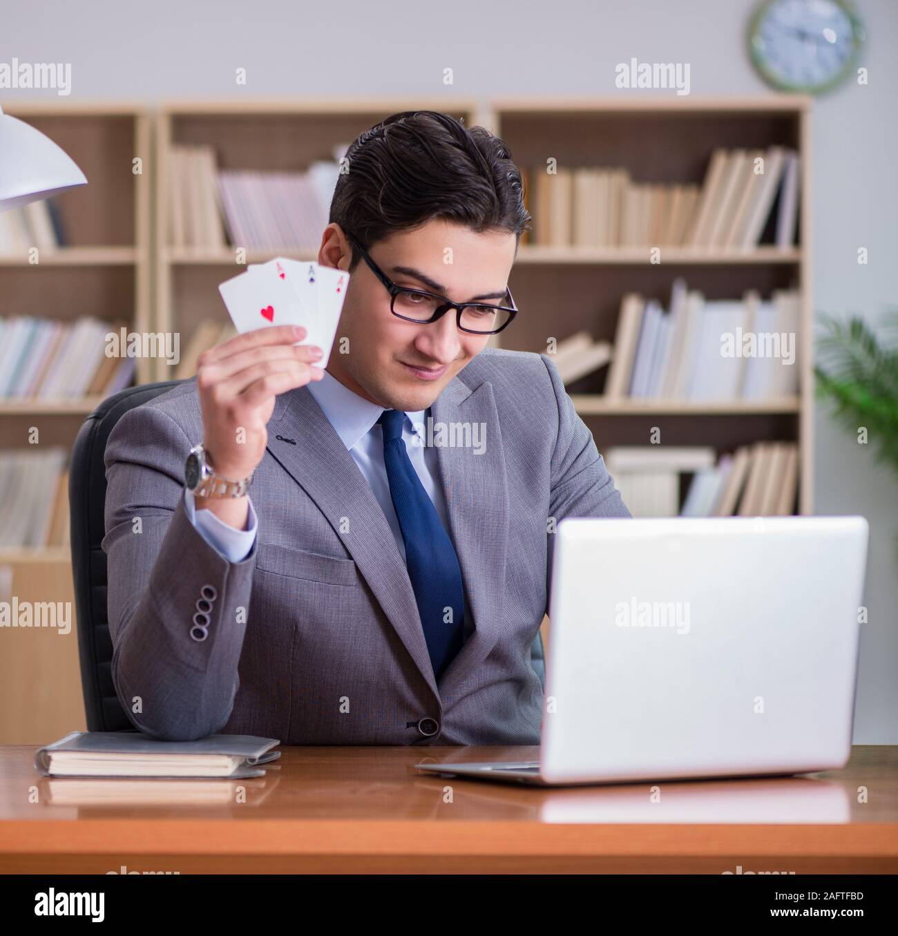 The businessman gambling playing cards at work Stock Photo - Alamy