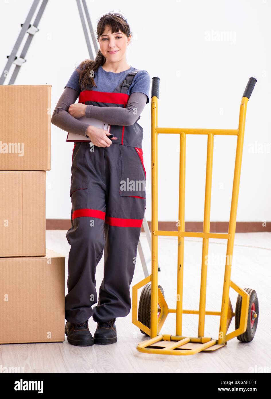 The woman contractor moving boxes in relocation concept Stock Photo - Alamy