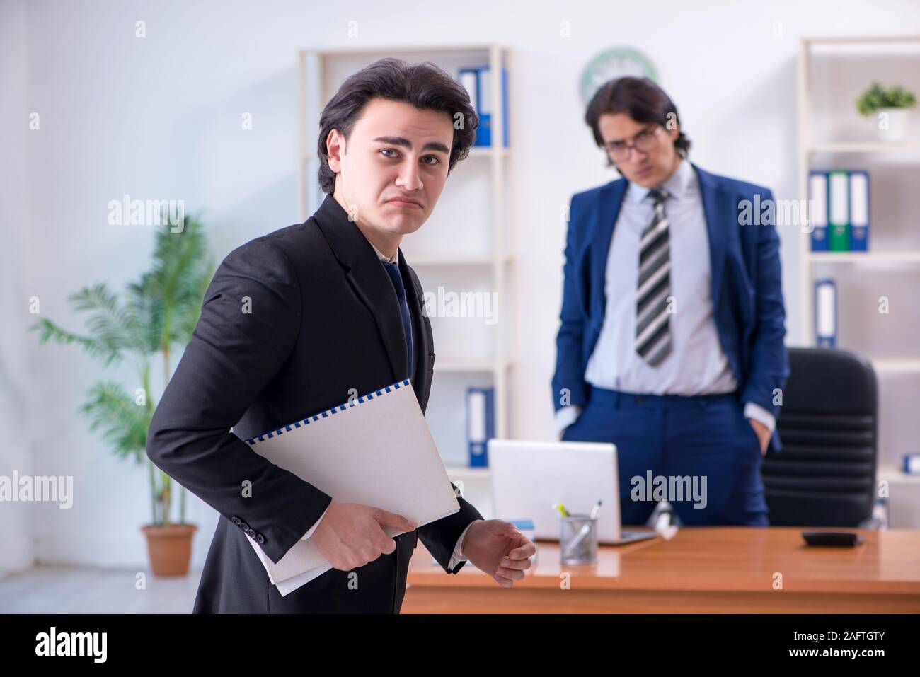 The boss and his male assistant working in the office Stock Photo - Alamy
