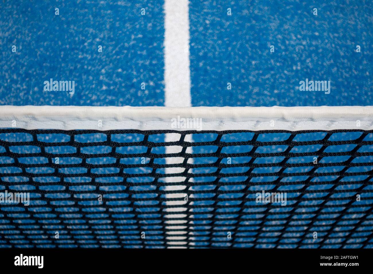 Blue paddle tennis net and court field background Stock Photo - Alamy