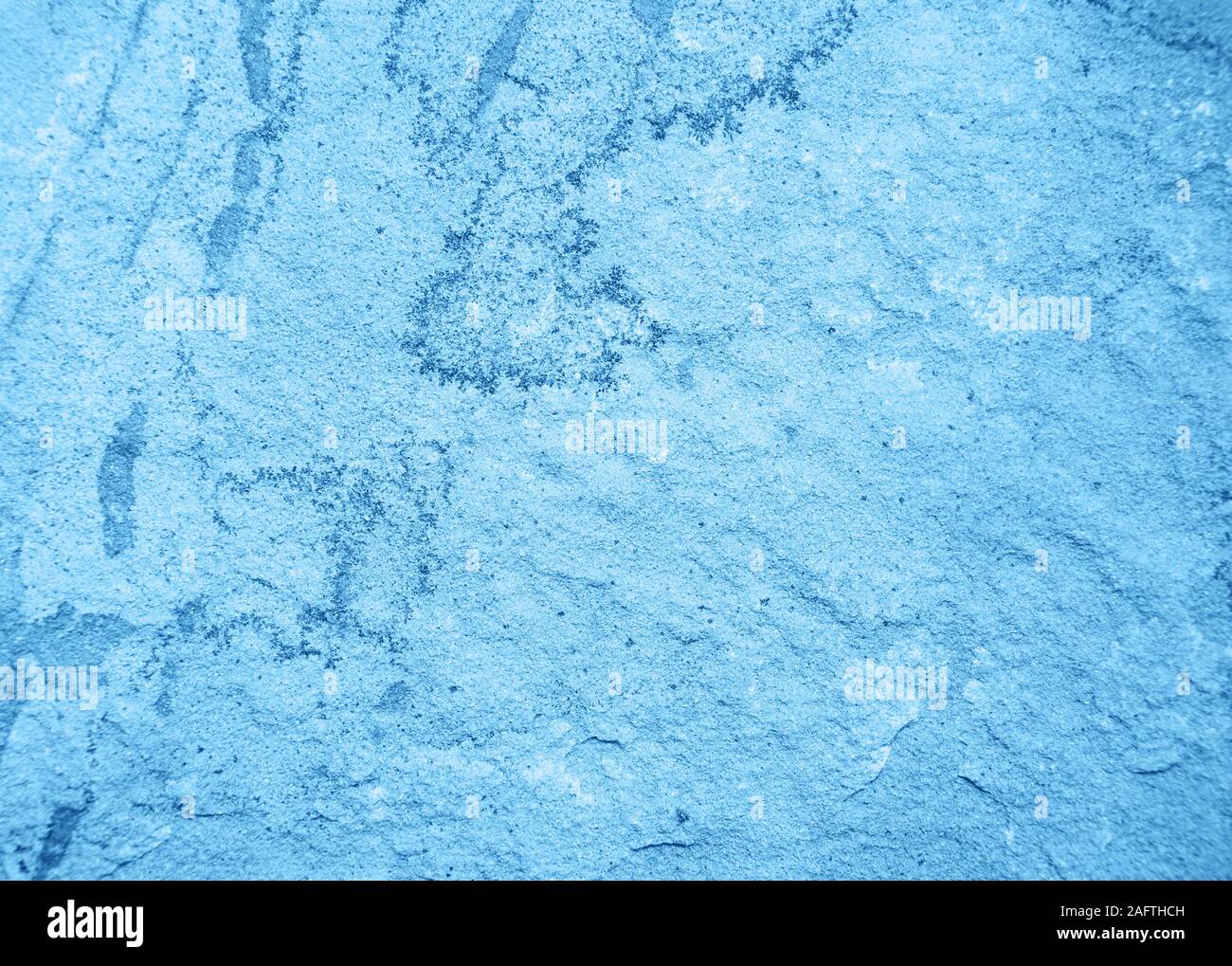Ancient stone wall, background or texture toned classic blue color ...