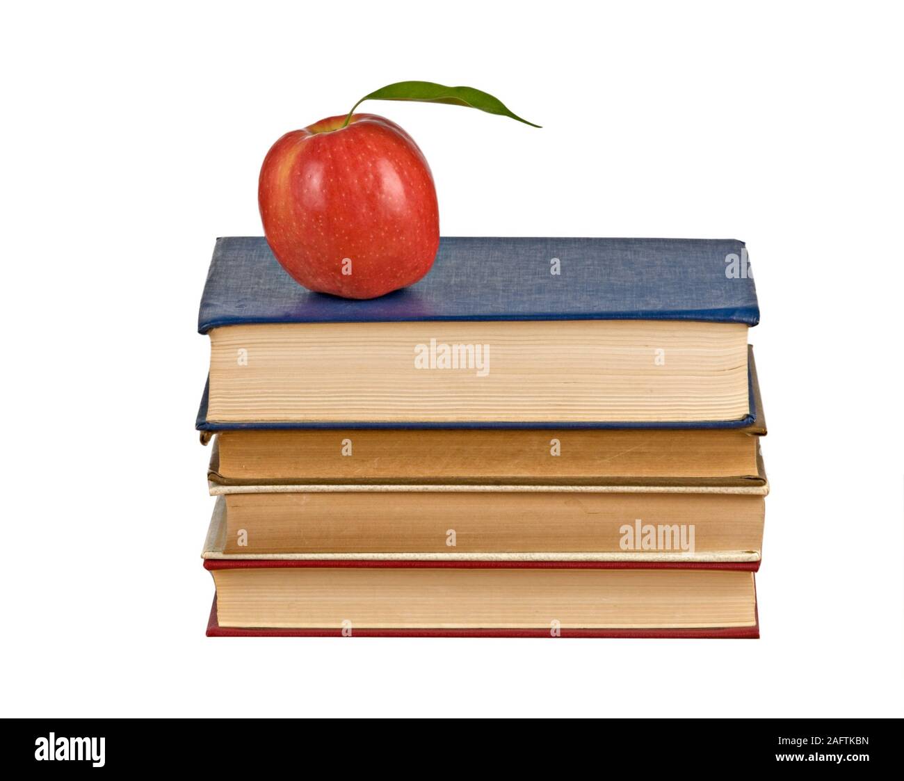 Apple on book isolated on white background Stock Photo - Alamy