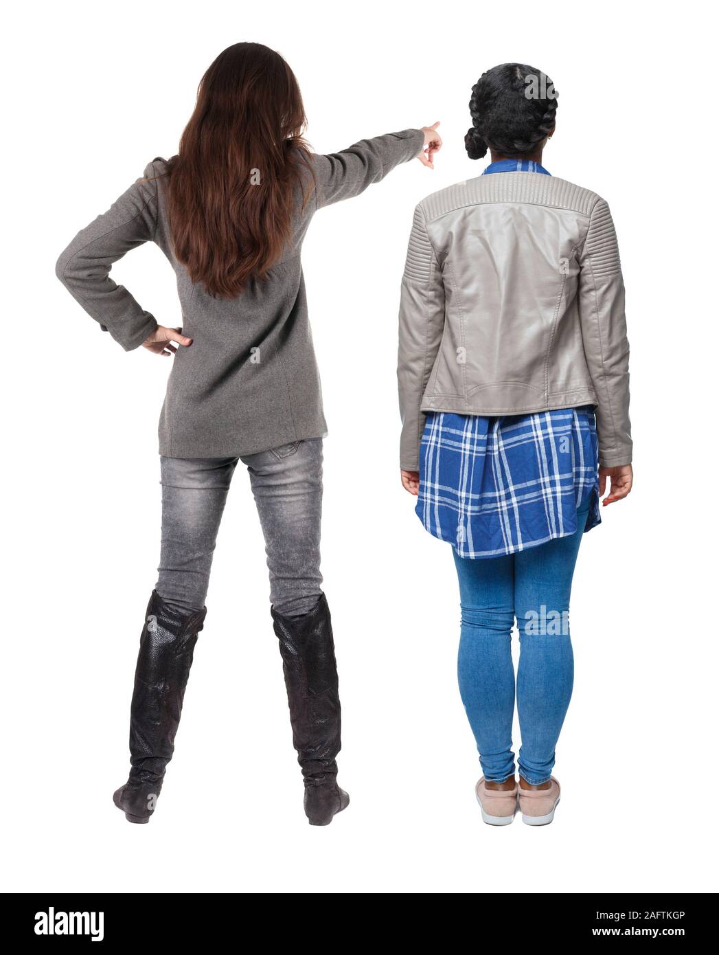 Back view of two pointing young girl in winter jacket. Rear view people ...