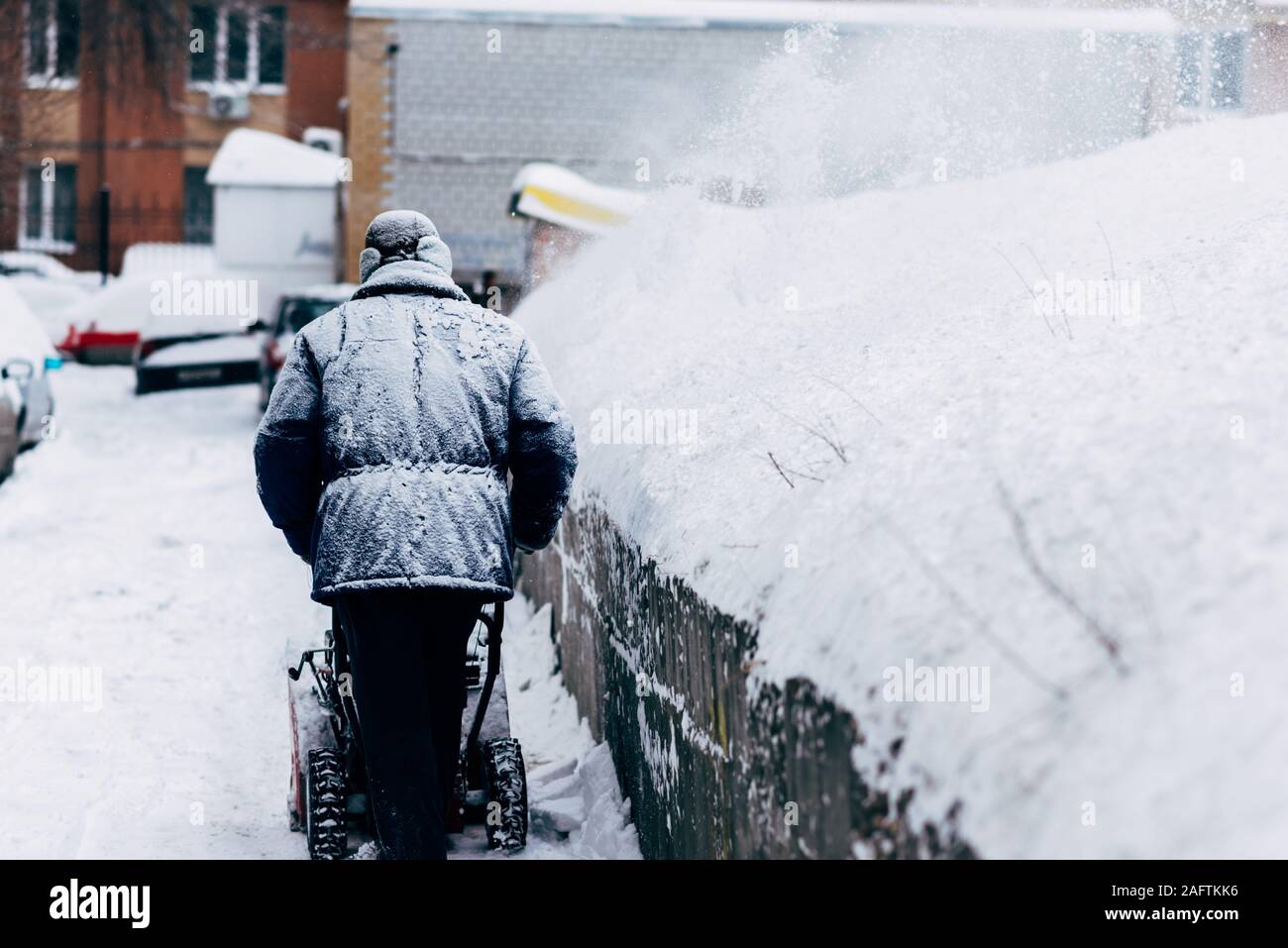 Man cleans snow thrower hi-res stock photography and images - Alamy