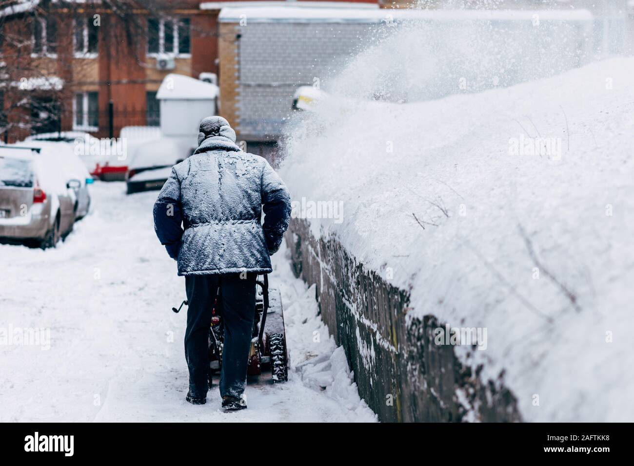 Man cleans snow thrower hi-res stock photography and images - Alamy