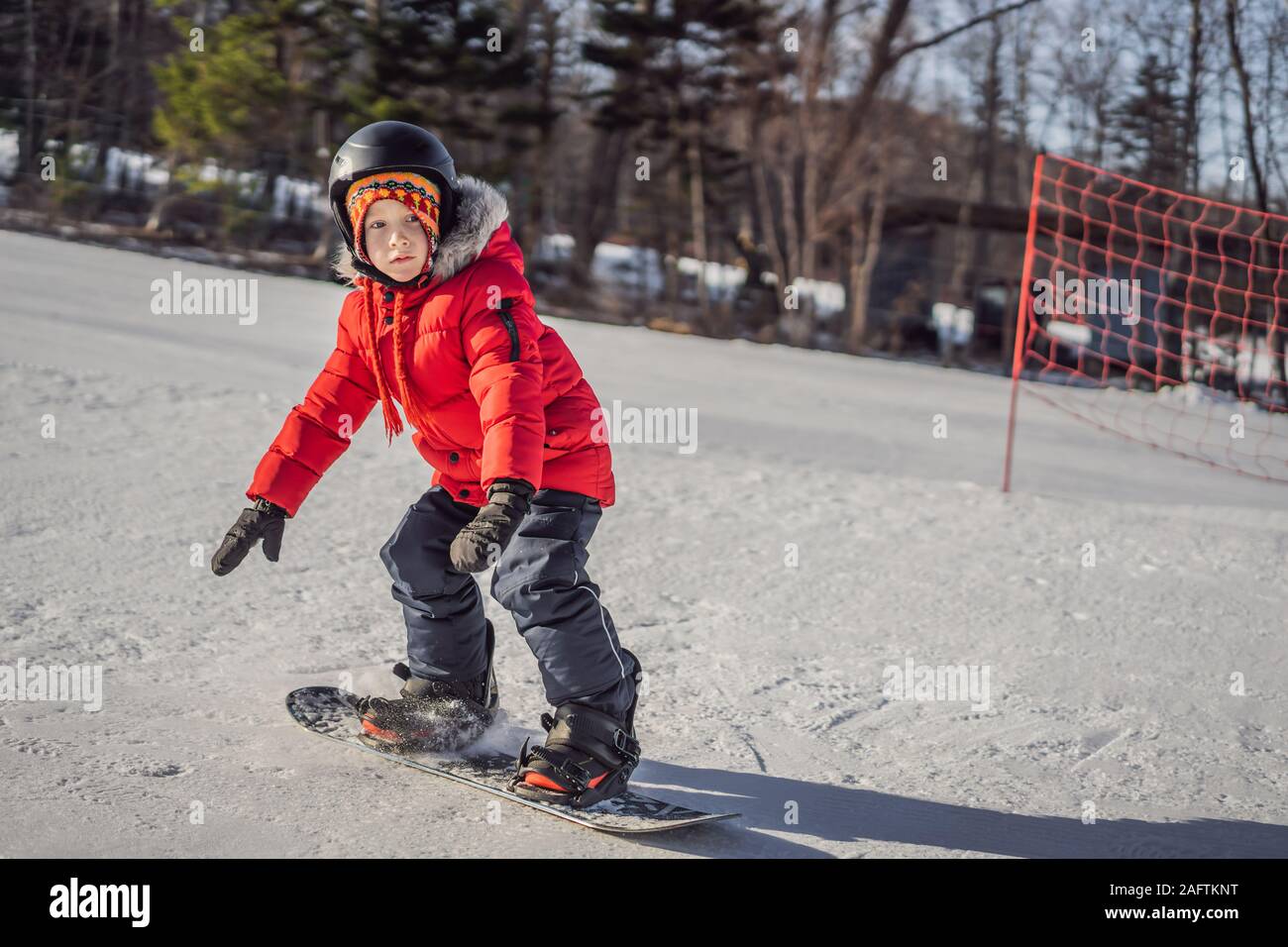 Little cute boy snowboarding. Activities for children in winter ...