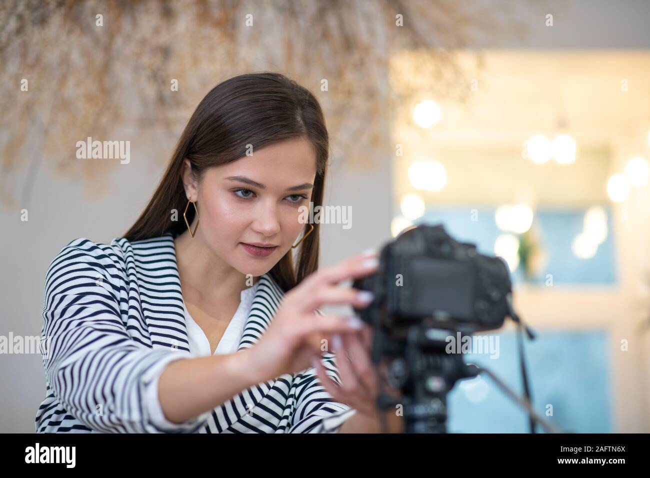 Pretty attractive woman looking into the camera Stock Photo - Alamy