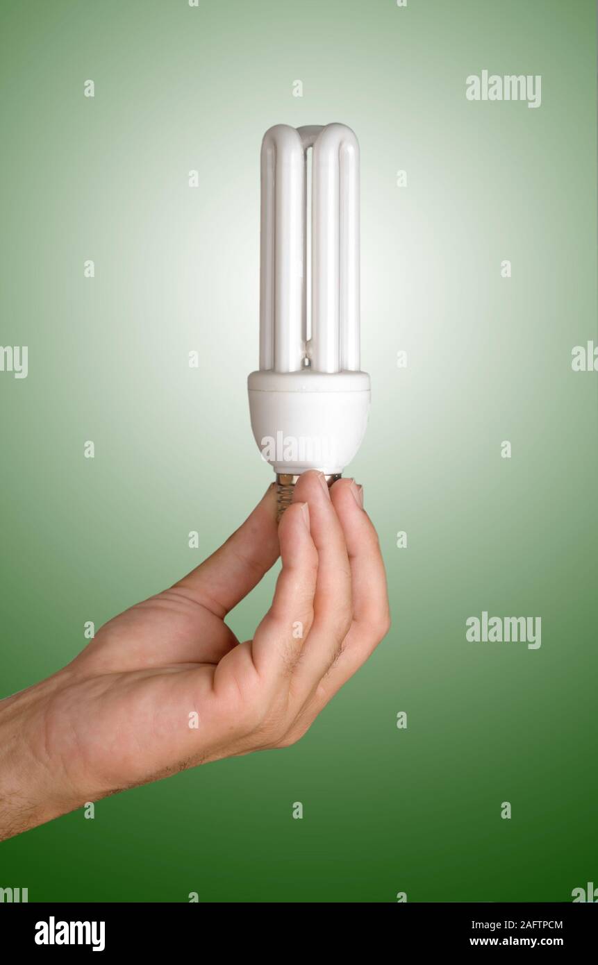 hand holding an energy-saving lamp Stock Photo - Alamy