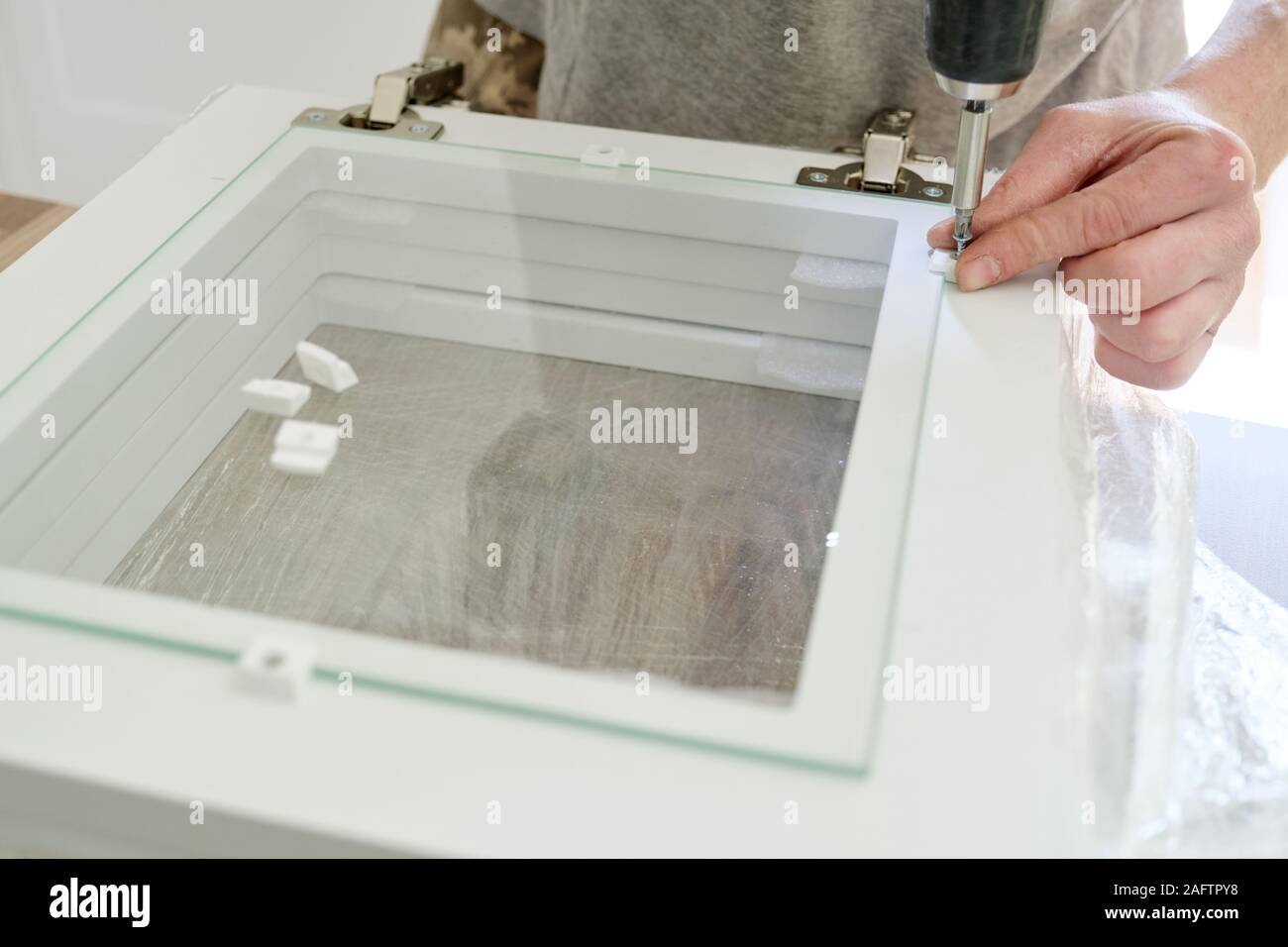 Closeup of workers hand with professional tools and furniture details ...