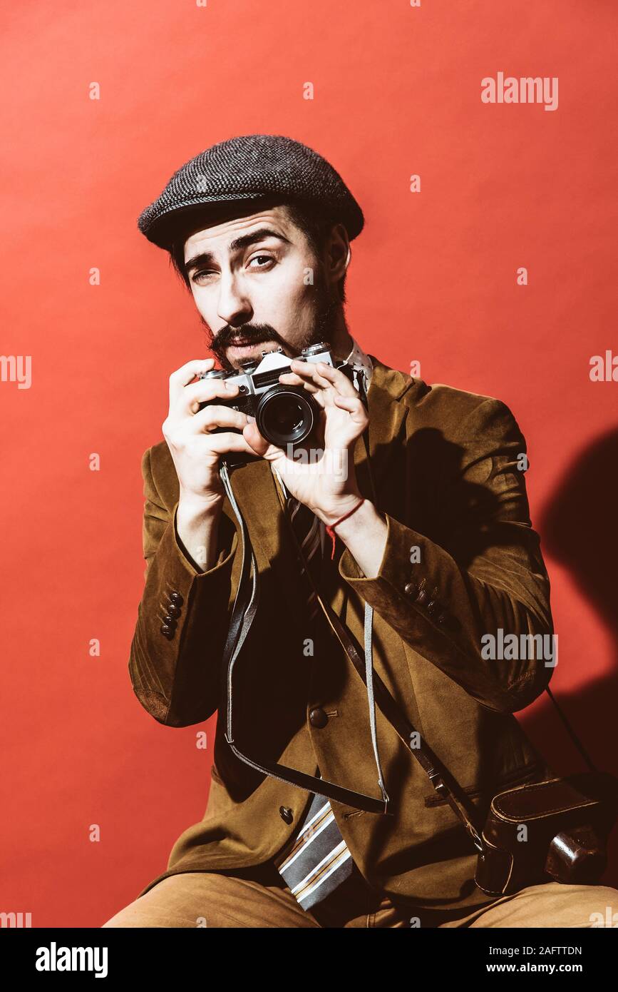 very positive photographer posing in studio with camera Stock Photo - Alamy