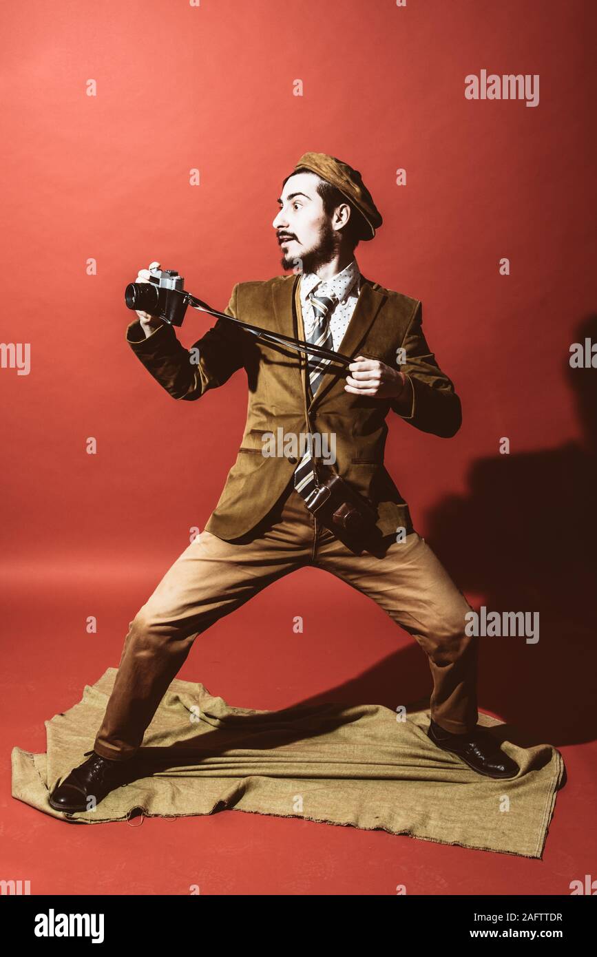 very positive photographer posing in studio with camera Stock Photo - Alamy