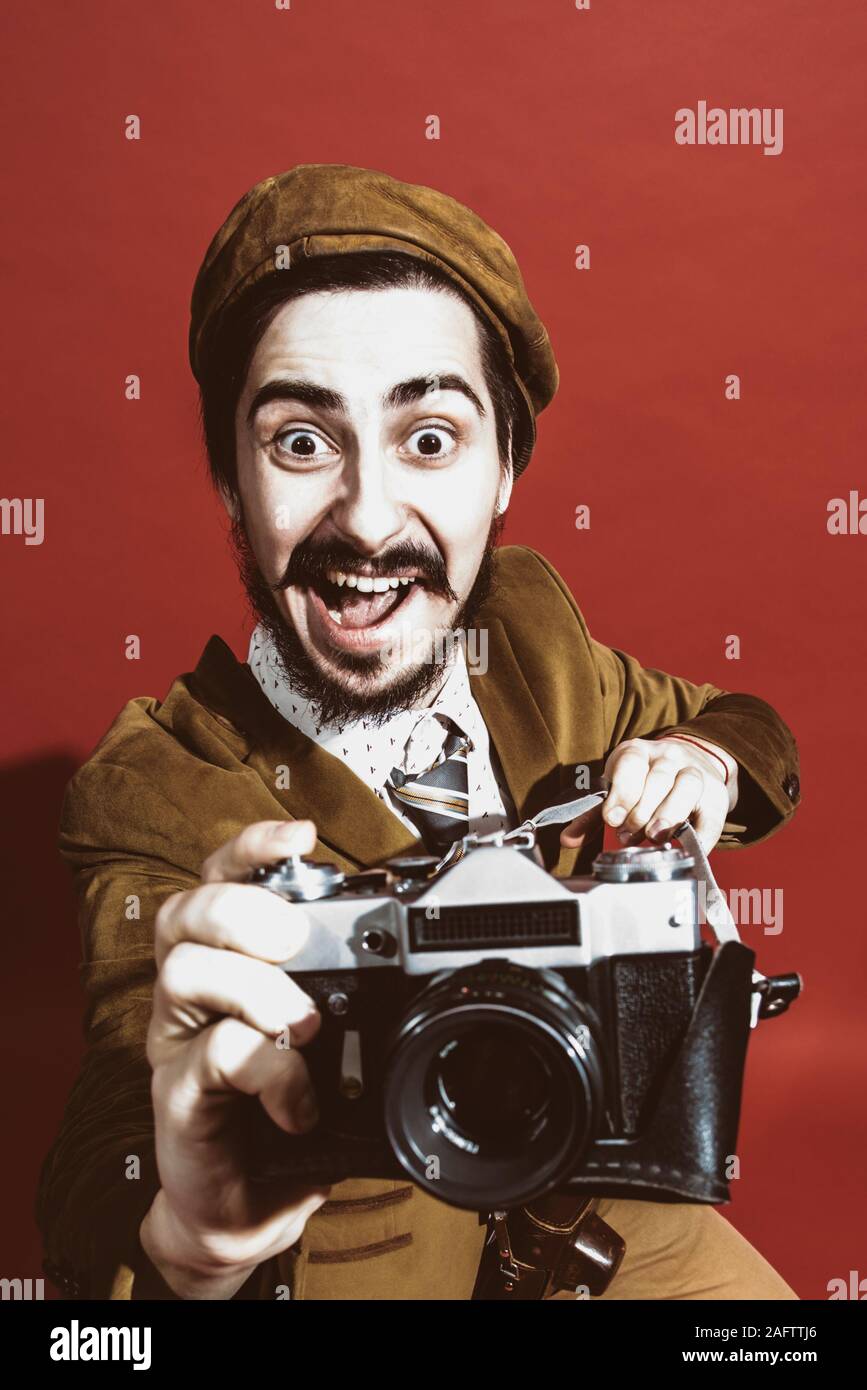 very positive photographer posing in studio with camera Stock Photo - Alamy