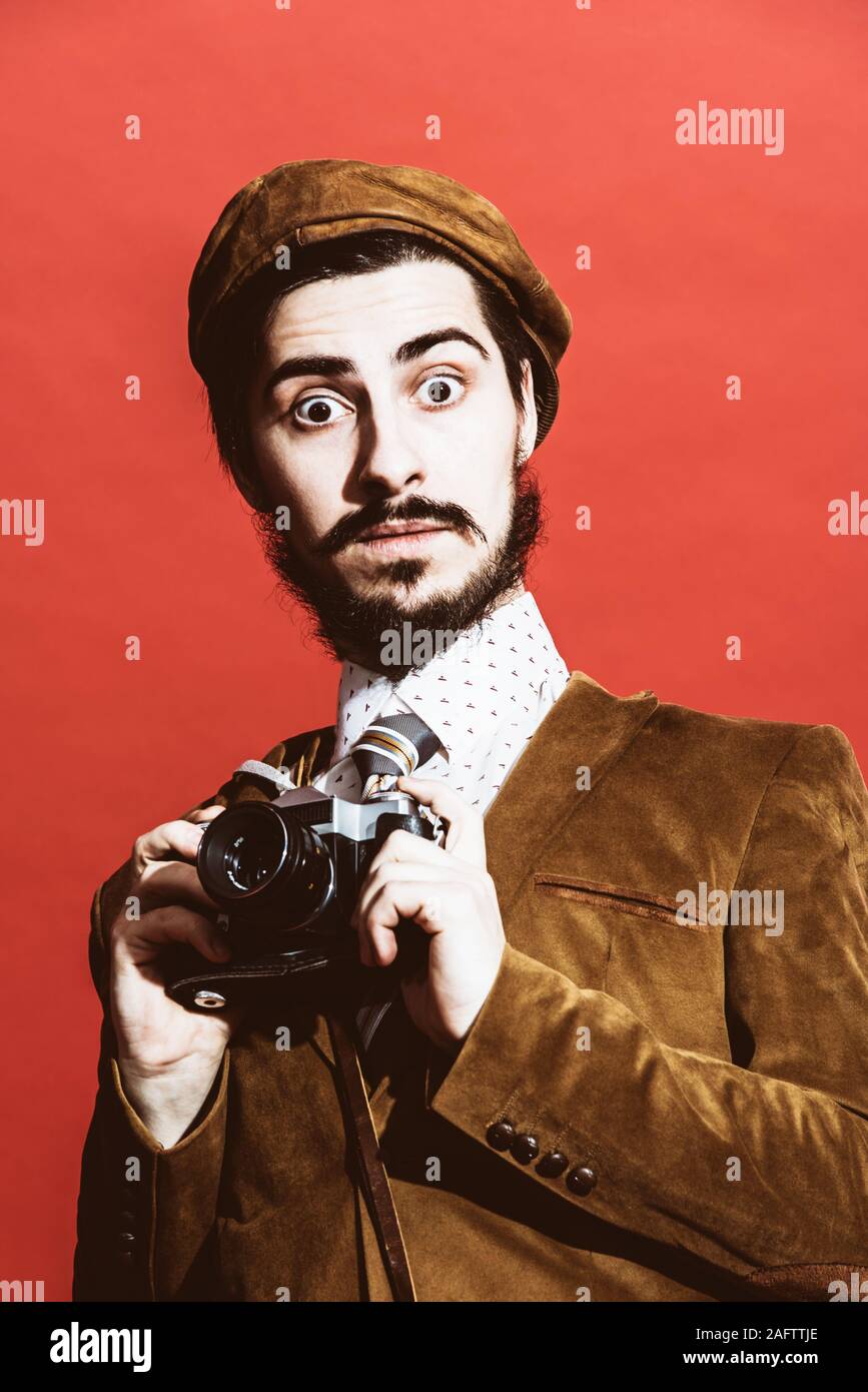 very positive photographer posing in studio with camera Stock Photo - Alamy