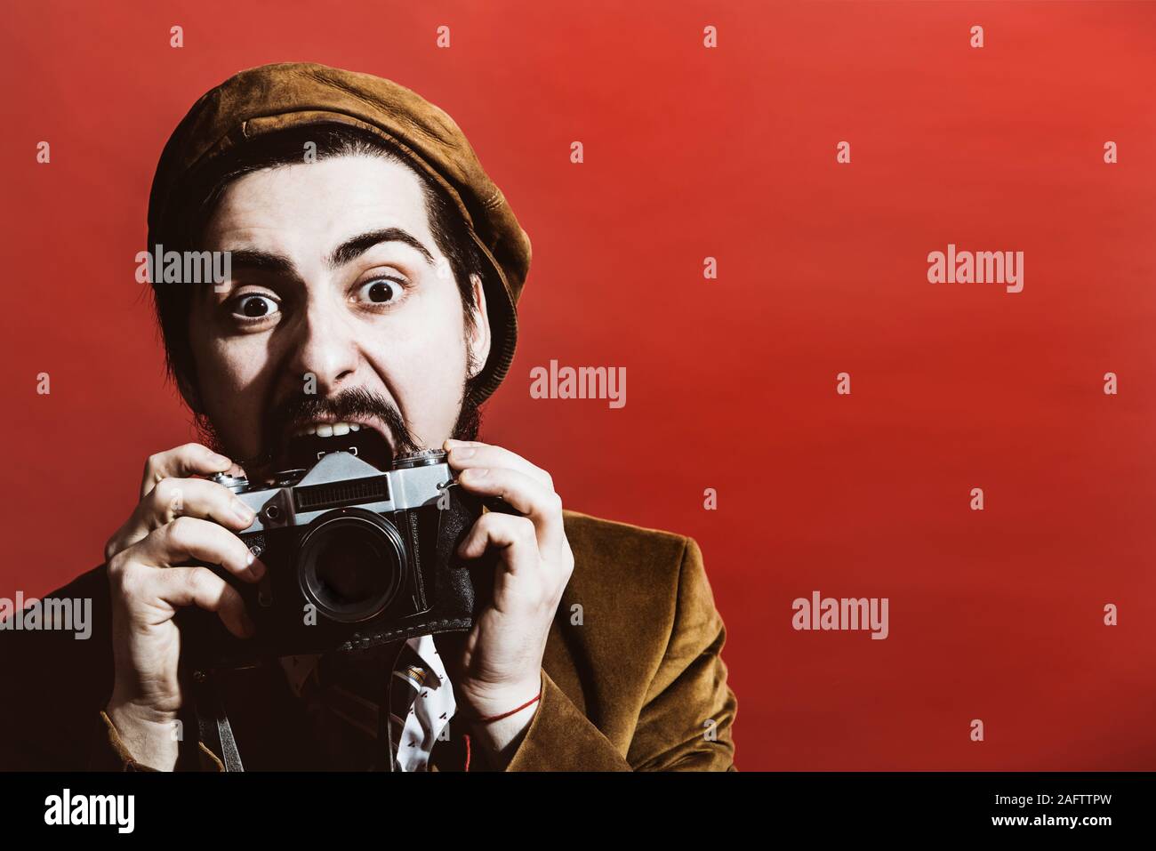 very positive photographer posing in studio with camera Stock Photo - Alamy